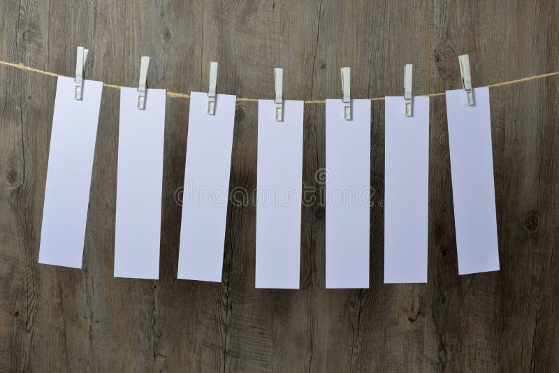 Seven Sheets of Paper Hanging Stock Image - Image of displays, marking ...