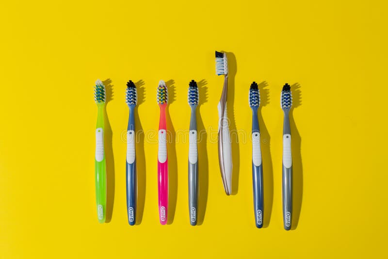 Seven Toothbrushes Lie on a Yellow Background. Stock Photo - Image of ... Seven Toothbrushes Lie on a Yellow Background. Stock Photo - Image of ...