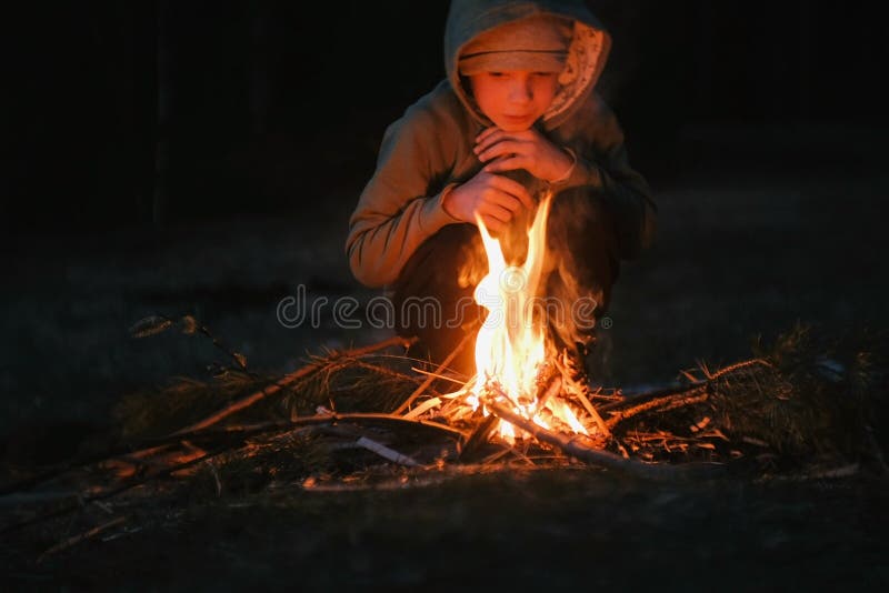 Seven-year-old Boy Light a Fire in the Woods. Stock Photo - Image of ...
