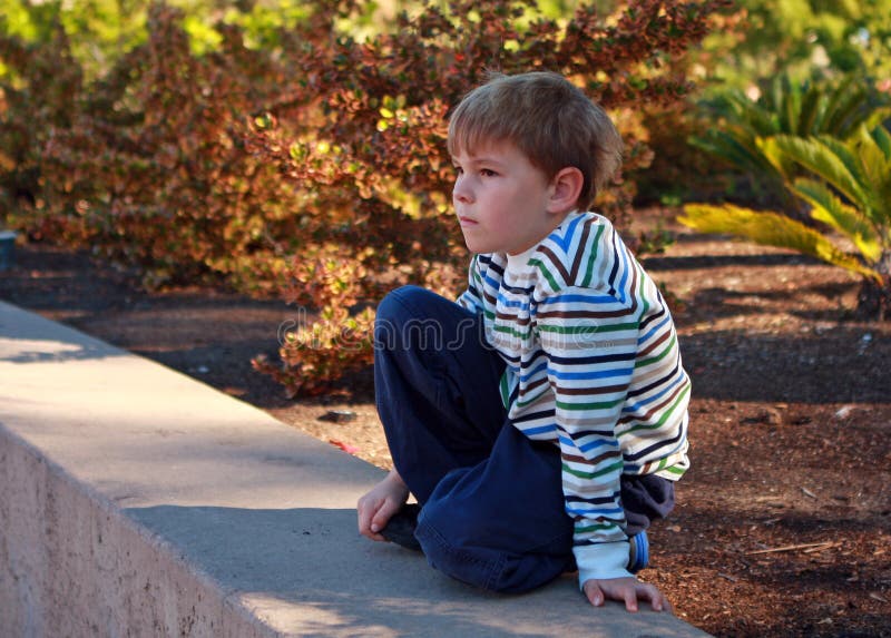 Seven year old boy staring stock image. Image of relaxing - 12543185