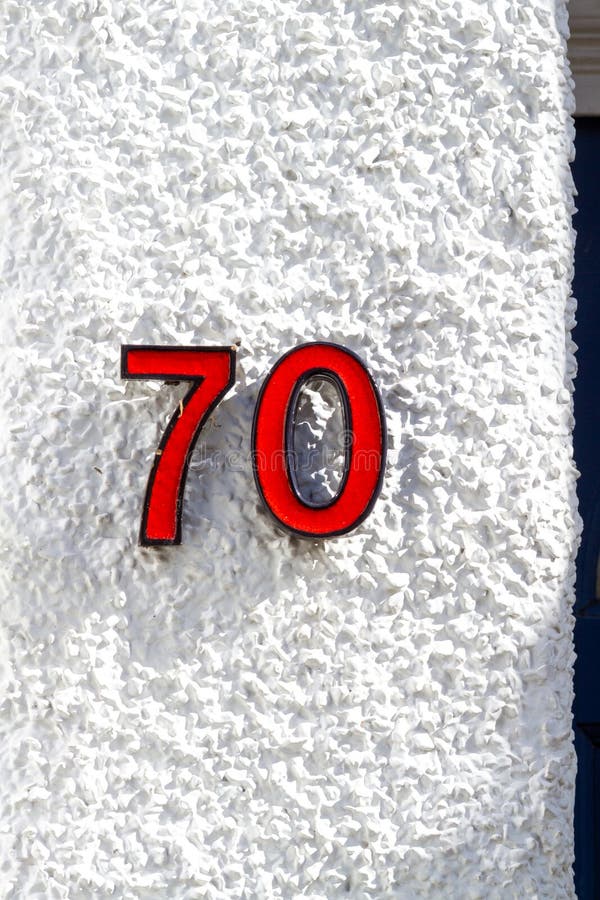Bright Red Number 70 on a Wall Stock Image - Image of outside, house ...