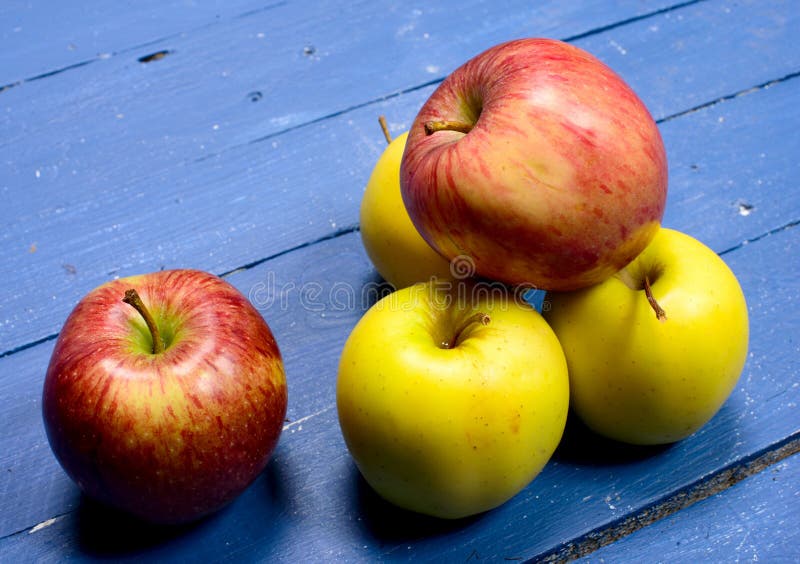 Several Apples Placed on a Table Painted Blue Stock Photo - Image of ...