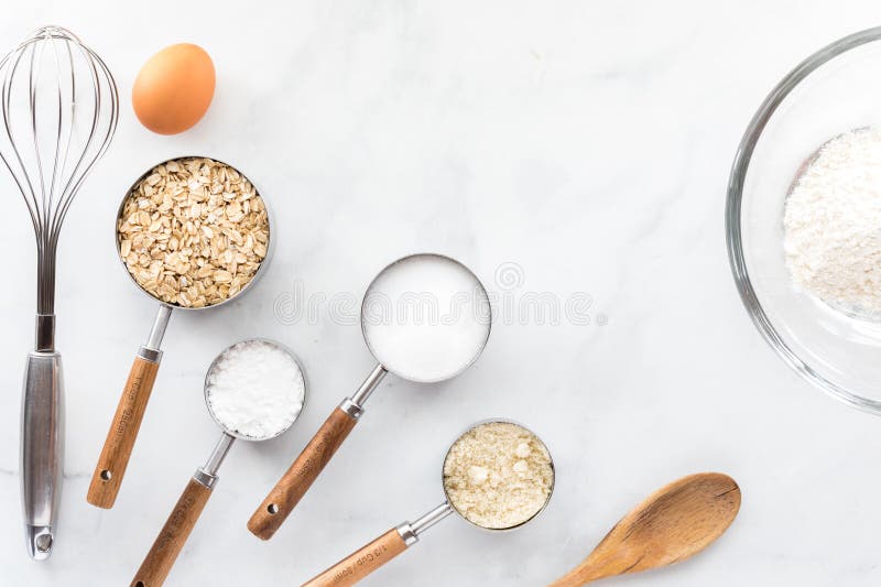 Several Baking Utensils with Ingredients on a White Marble Table. Stock ...