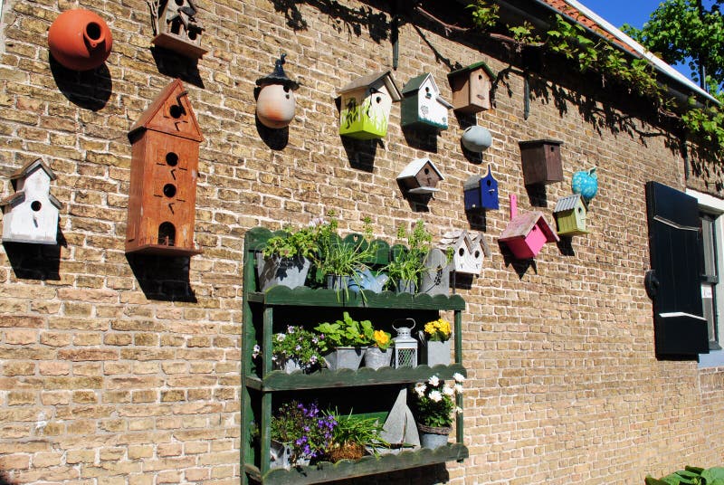 Several Bird Houses on an Brick Wall Stock Photo - Image of green ...