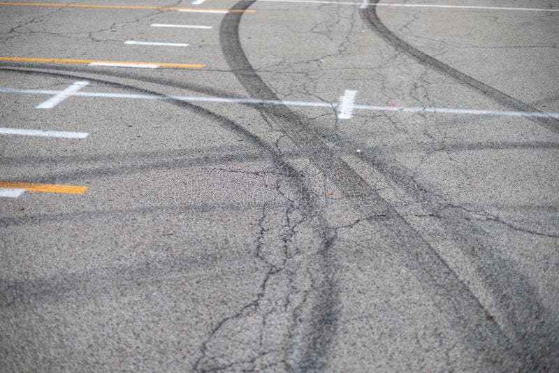 Several Black Car Tracks in the Middle of a Parking Lot Stock Image ...