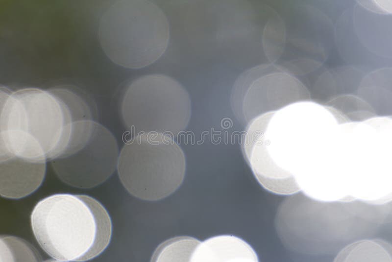 Several Blurry Sun Spots Reflected in Water Stock Image - Image of ...