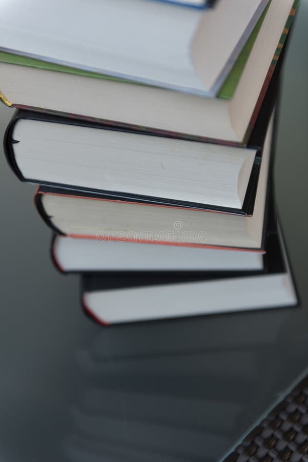Several Books As a Stack on a Glass Table Stock Image - Image of books ...