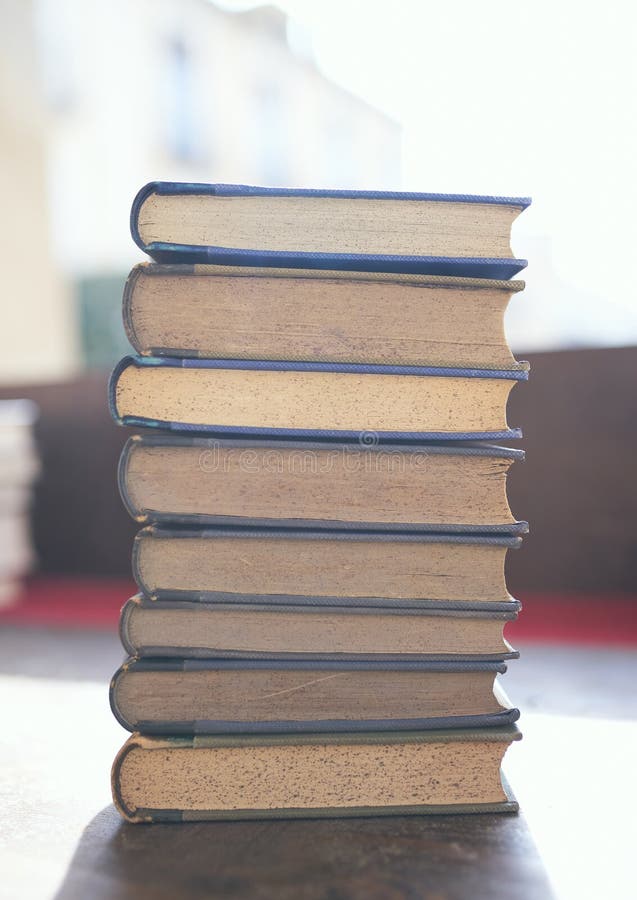 Several Books Stacked in a Tower on a Desk Stock Image - Image of group ...