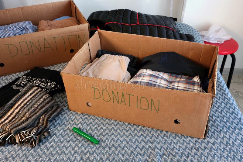 Several Cardboard Boxes for Donations with Things. Winter and Summer ...