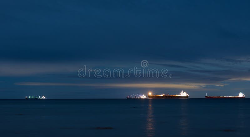 Several Cargo Ships at Night in the Middle of the Sea Stock Image ...