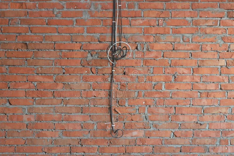 Several Electrical Cables on a Brick Wall for the Installation of ...