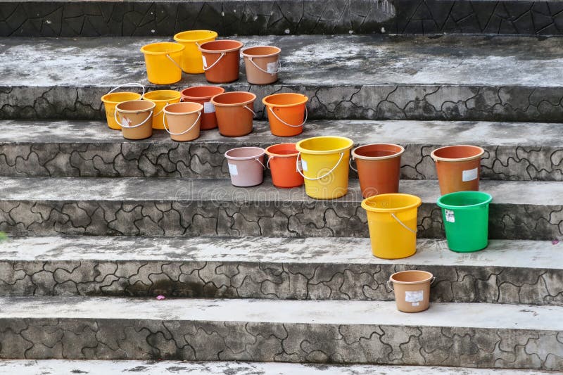 Several Empty Plastic Buckets of Various Colors Were Placed Along the ...
