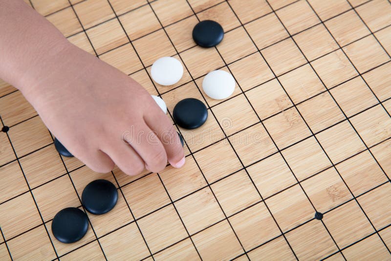 Several Go Chess Pieces Scattered on the Go Board Stock Photo - Image ...