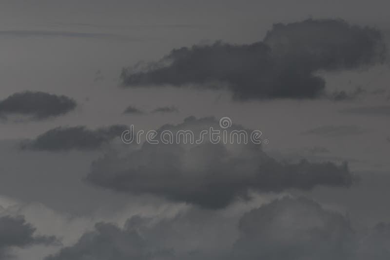 Several Isolated Dark Clouds in Gray Sky Stock Photo - Image of dark ...