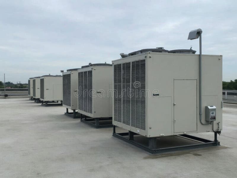 Several Large HVAC Units are Lined Up on a Flat Rooftop, Surrounded by ...