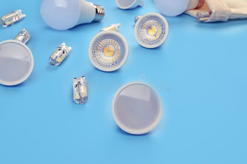 Several LED Bulb on Blue Background. Saving Energy Concept. Ftat Lay ...