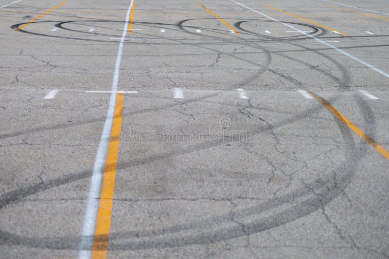 Several Looping Car Tracks in the Middle of a Parking Lot Stock Image ...