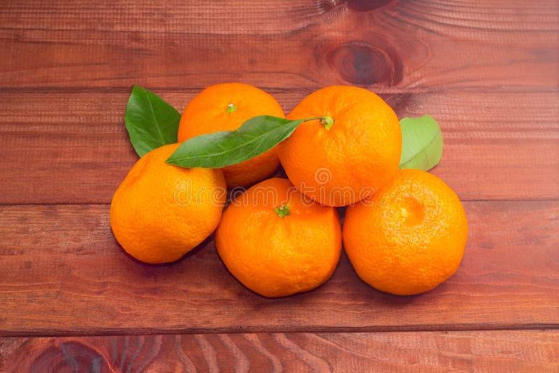 Several Mandarin Oranges on a Dark Wooden Surface Stock Photo - Image ...