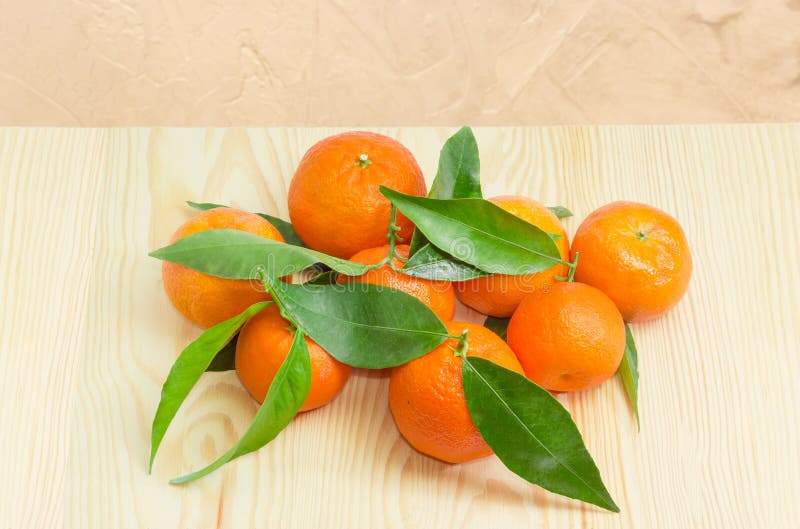 Several Mandarin Oranges on a Light Wooden Surface Stock Image - Image ...