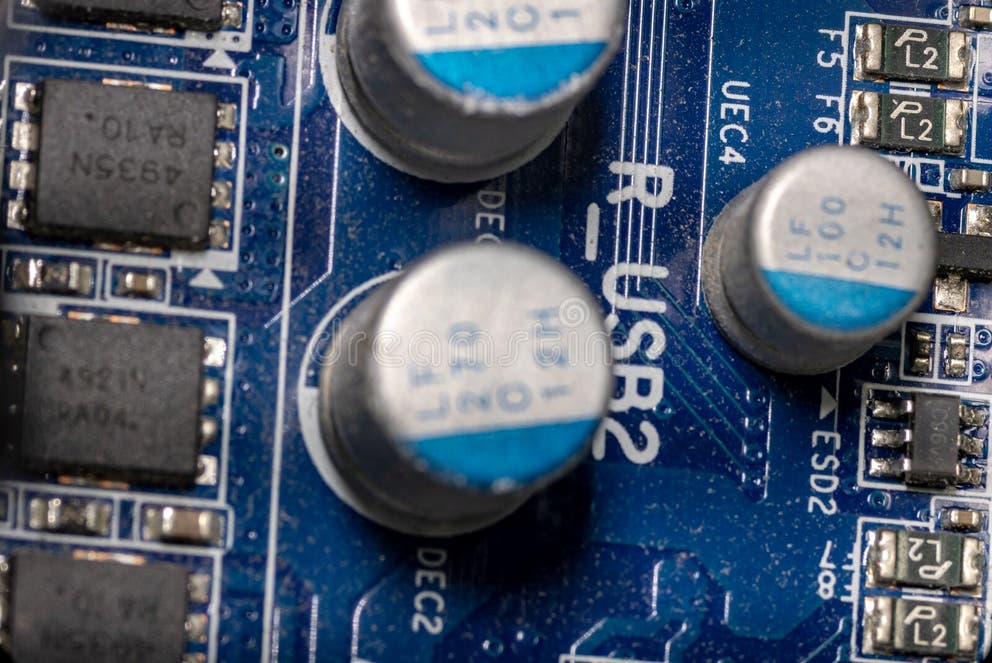 Several Microcircuits and Transistors on a Blue Motherboard in a Close ...