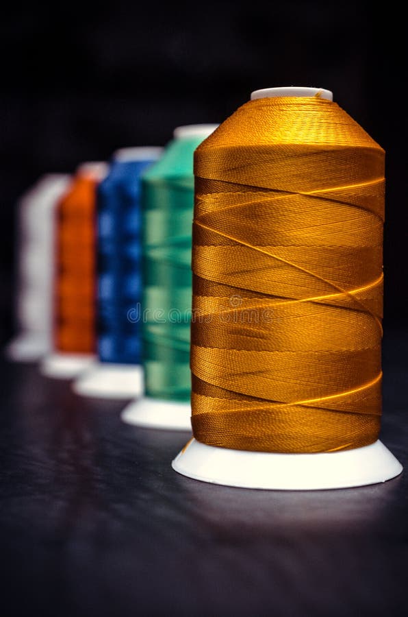 Several of Multi-colored Spools of Threads. Perspective on a Black ...