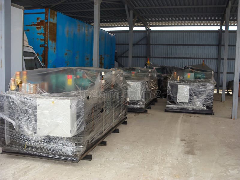 Several New Industrial Machines are Wrapped and Await Installation in a ...