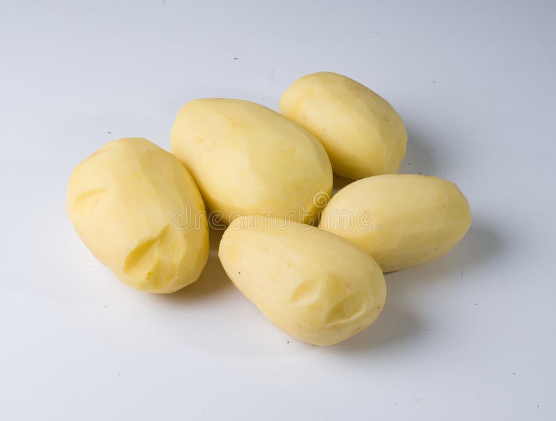 Several Peeled Potatoes on a White Surface. Preparation for Cooking ...