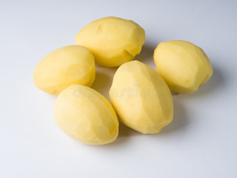 Several Peeled Potatoes on a White Surface. Preparation for Cooking ...