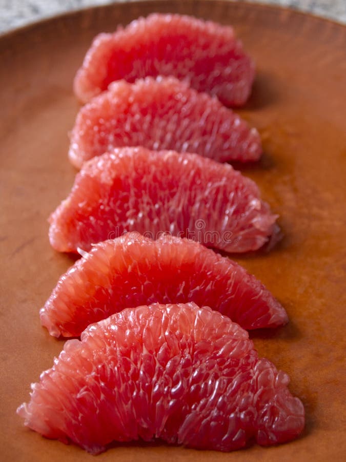 Several Pieces of Peeled Grapefruit are Laid Out in a Row Stock Photo ...