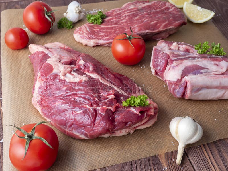 Several Pieces of Raw Marbled Black Angus Beef Lie on Parchment ...