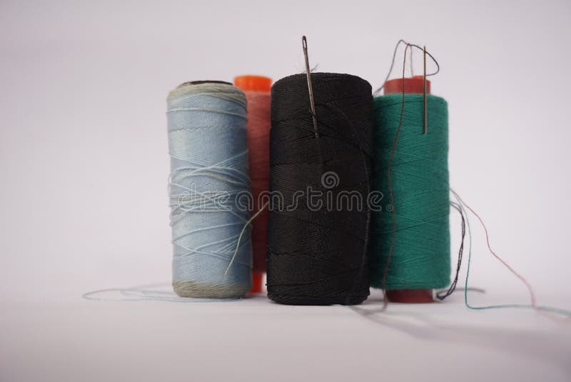 Several Piles of Sewing Thread Spools of Various Colors Isolated on a ...