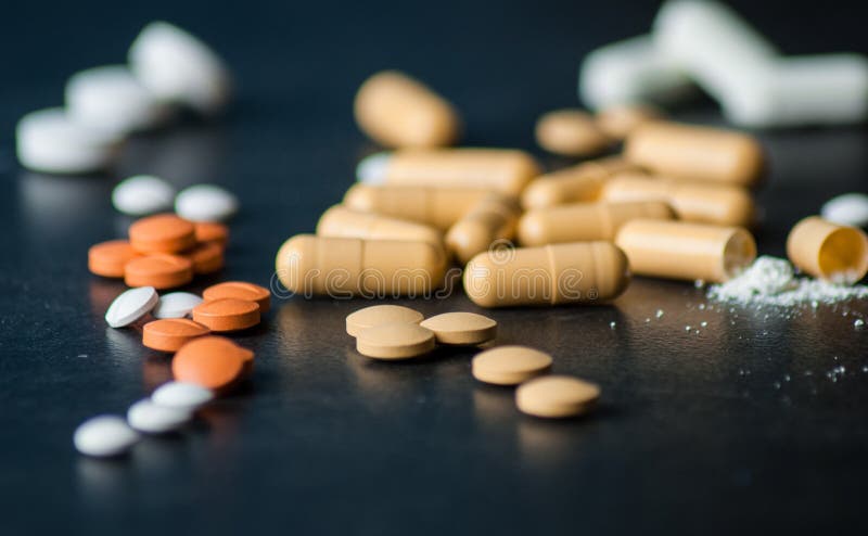 Several Pills, Antibiotics And Anti-inflammatory. On Dark Background ...