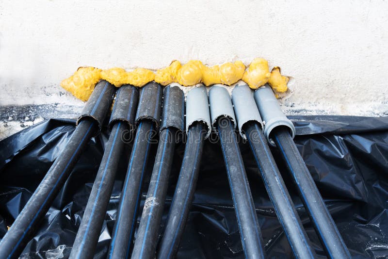 Several Plastic Pipes are Connected To the Front of the House ...