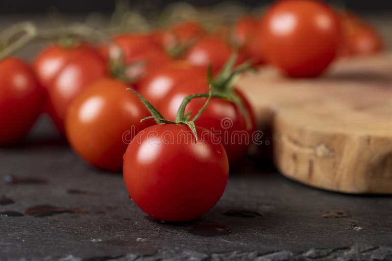 Several Round Cherry Tomatoes on the Table with Small Green Tails Stock ...