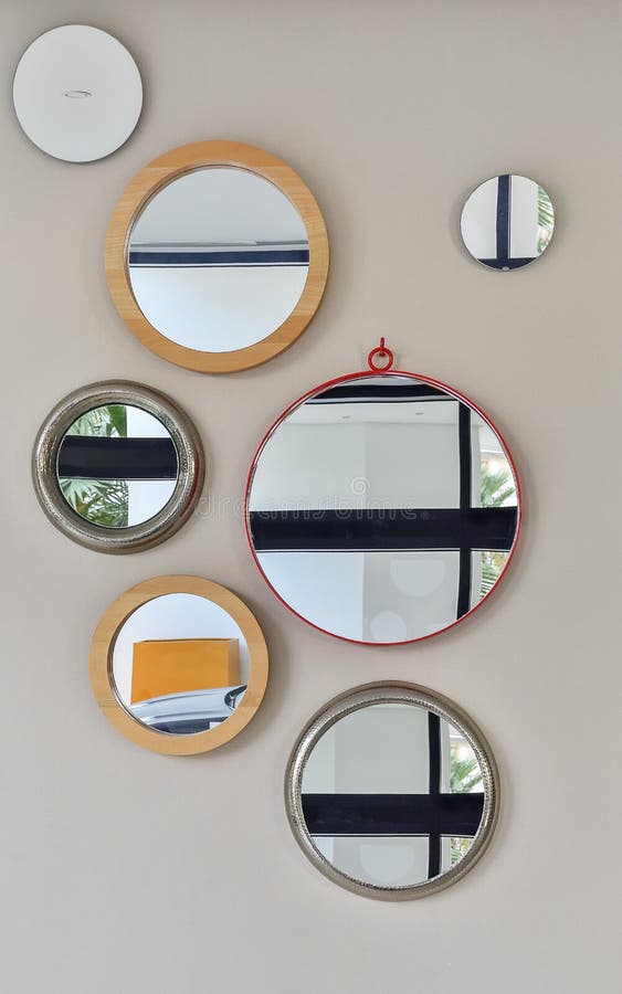 Several Round Mirrors in a Different Setting on the Wall in the Room ...