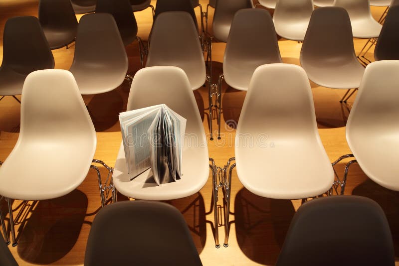 Several Rows of Chairs; Brochure Standing on Chair Stock Image - Image ...