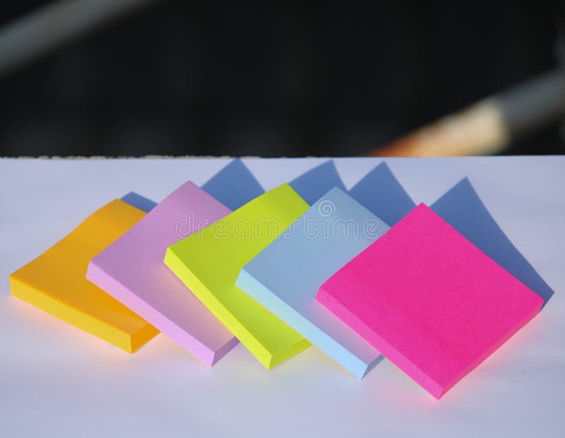 Several Sitcky Note Blocks Stacked in a Row on a Piece of White Paper ...