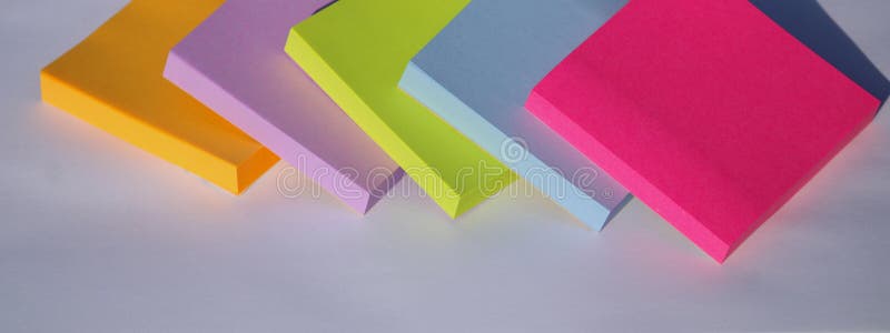Several Sitcky Note Blocks Stacked in a Row on a Piece of White Paper ...
