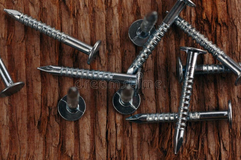 Several Small Nails on a Rough Wood Texture Background. Stock Image ...