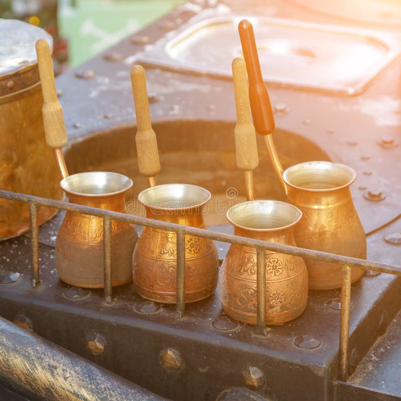 Several Smoked Pots for Making Turkish Coffee are Stand on a Metal ...