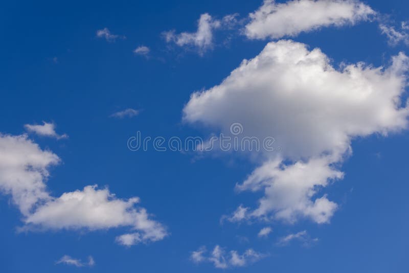 Several Snow-white Small Clouds Float Across the Bright Blue Spring Sky ...