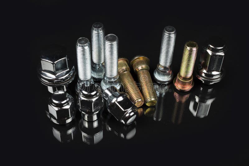 Several Studs and Nuts Fastening the Wheel of the Car on a Black ...