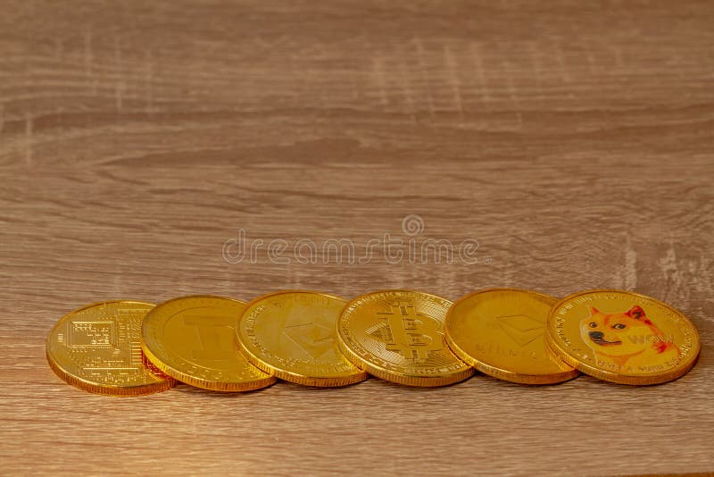 Several Types of Cryptocurrencies on Wooden Tables, the Value of Which ...