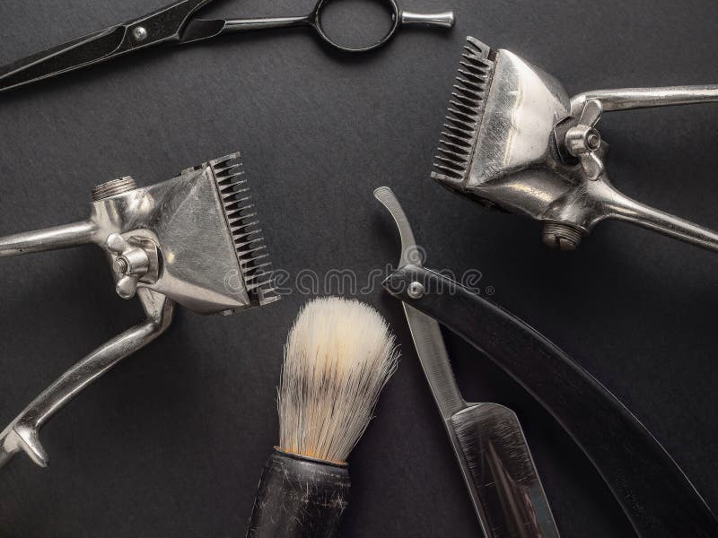 Several Vintage Barber Tools are Displayed on a Dark Surface, Including ...