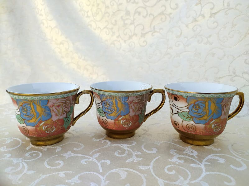 Several Vintage Cups with Floral Textures are Uniquely Arranged on the ...