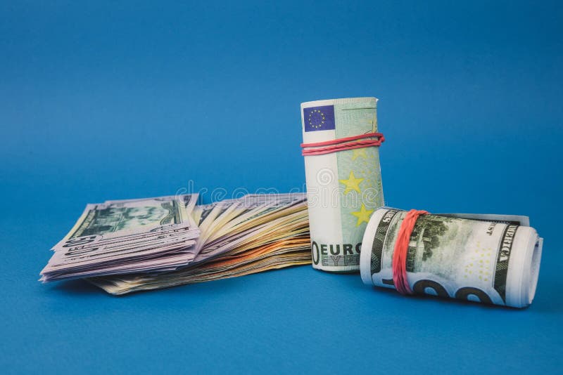 Several Wads of Money of Different Currencies on a Blue Background ...
