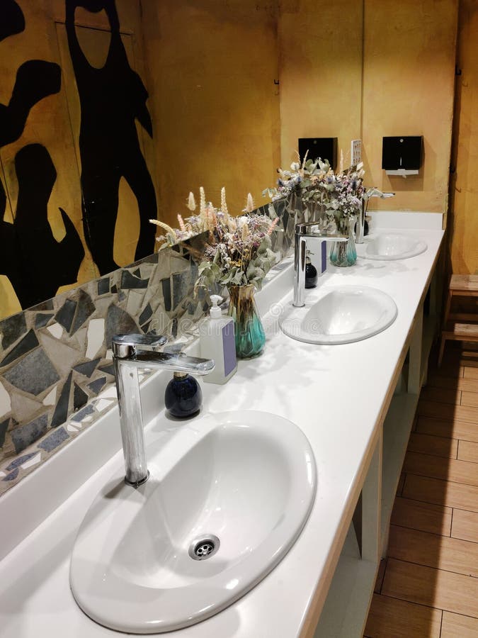 Several Wash Basins in Perspective with Decorations in a Public Toilet ...