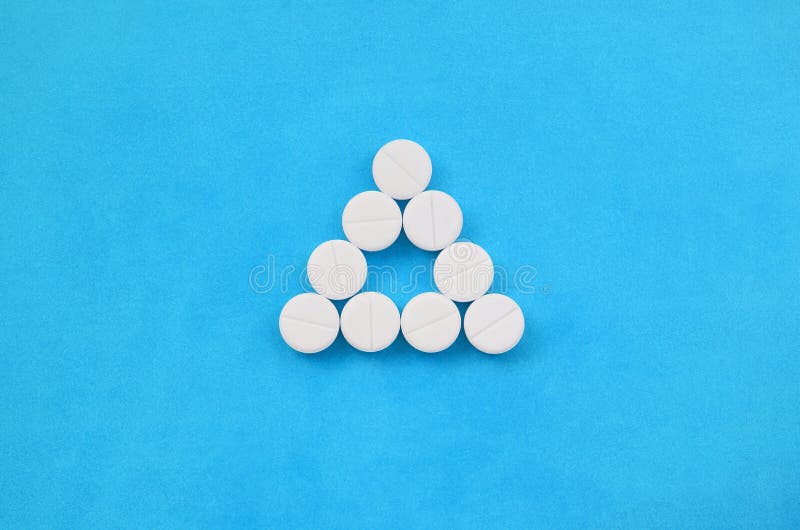 The Triangle Of Pills . Isolated On Blue Background Stock Photo - Image ...