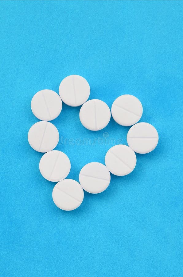 Several White Tablets Lie on a Bright Blue Background in the Shape of a ...