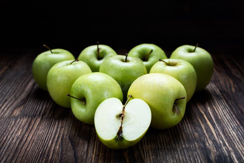 Several Whole Fresh Green Apples Grouped in a Triangle Form Lie on a ...